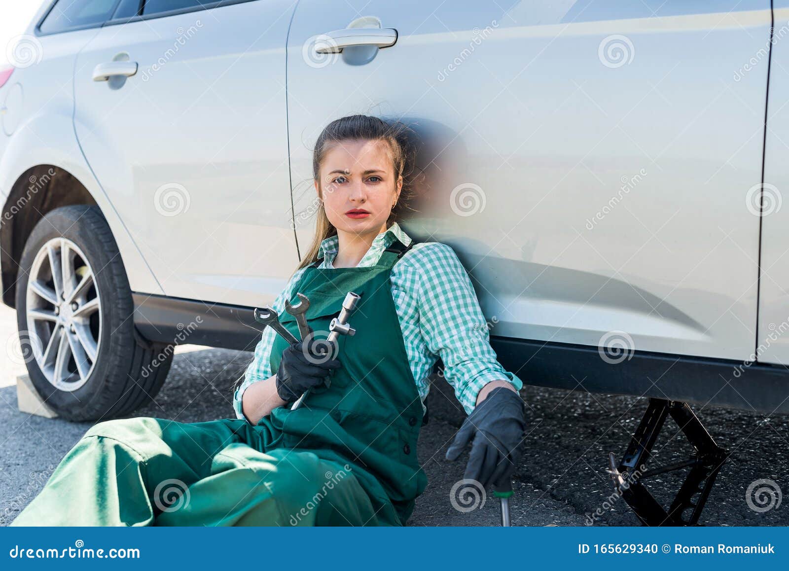 Tired Mechanic with Spare Wheel and Different Tools Stock Photo - Image ...