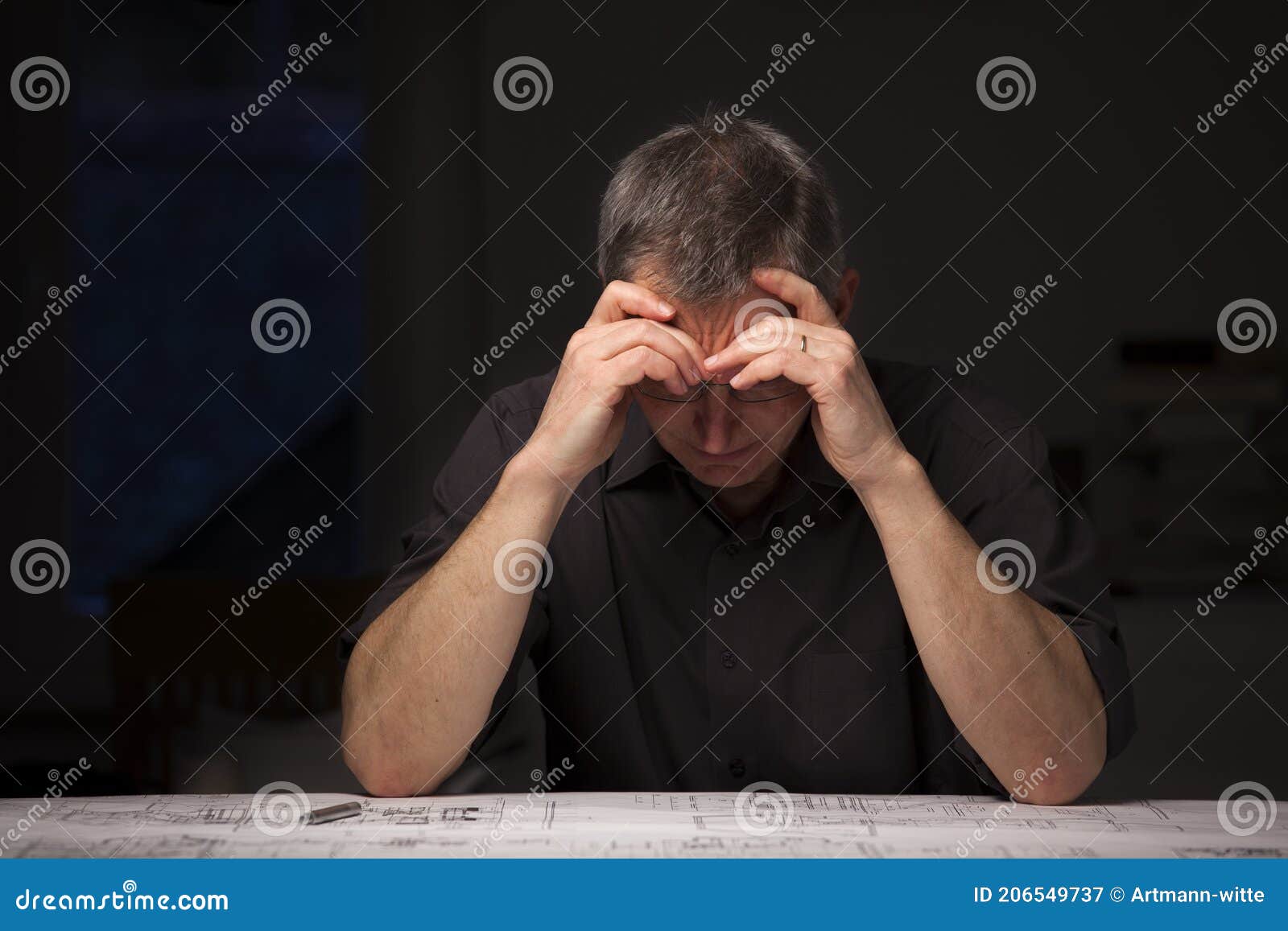 Tired and Overworked Architect or Engineer Sitting at Home at a Desk ...