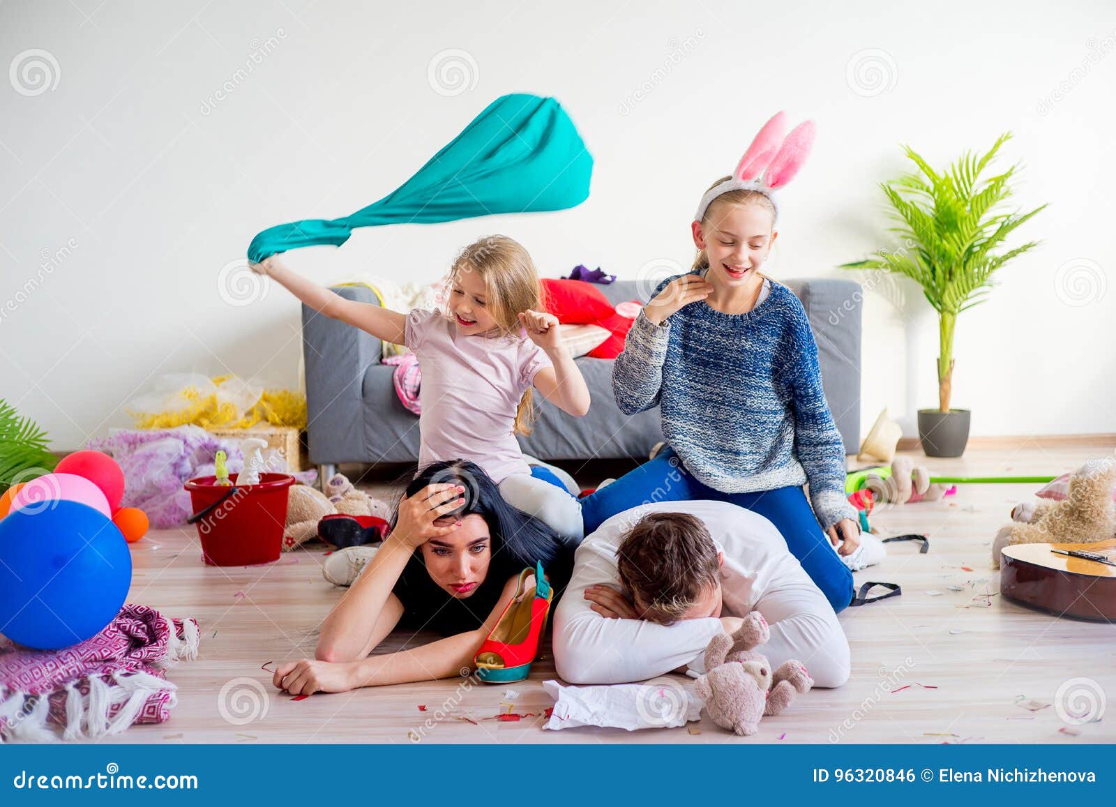 Tired Parents and Romping Kids Stock Photo - Image of overworked ...