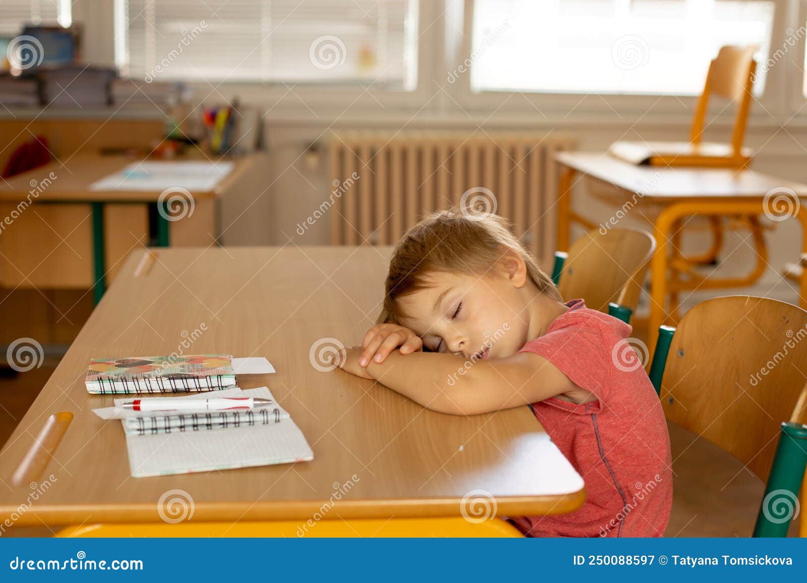 Tired Preschool Child, Sitting on a Desk at School, Having Lesson ...