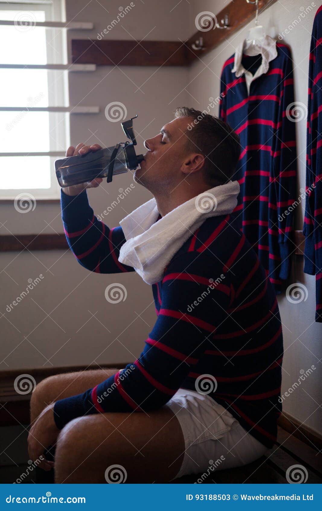 Tired Rugby Player Drinking Water while Sitting on Bench Stock Image ...