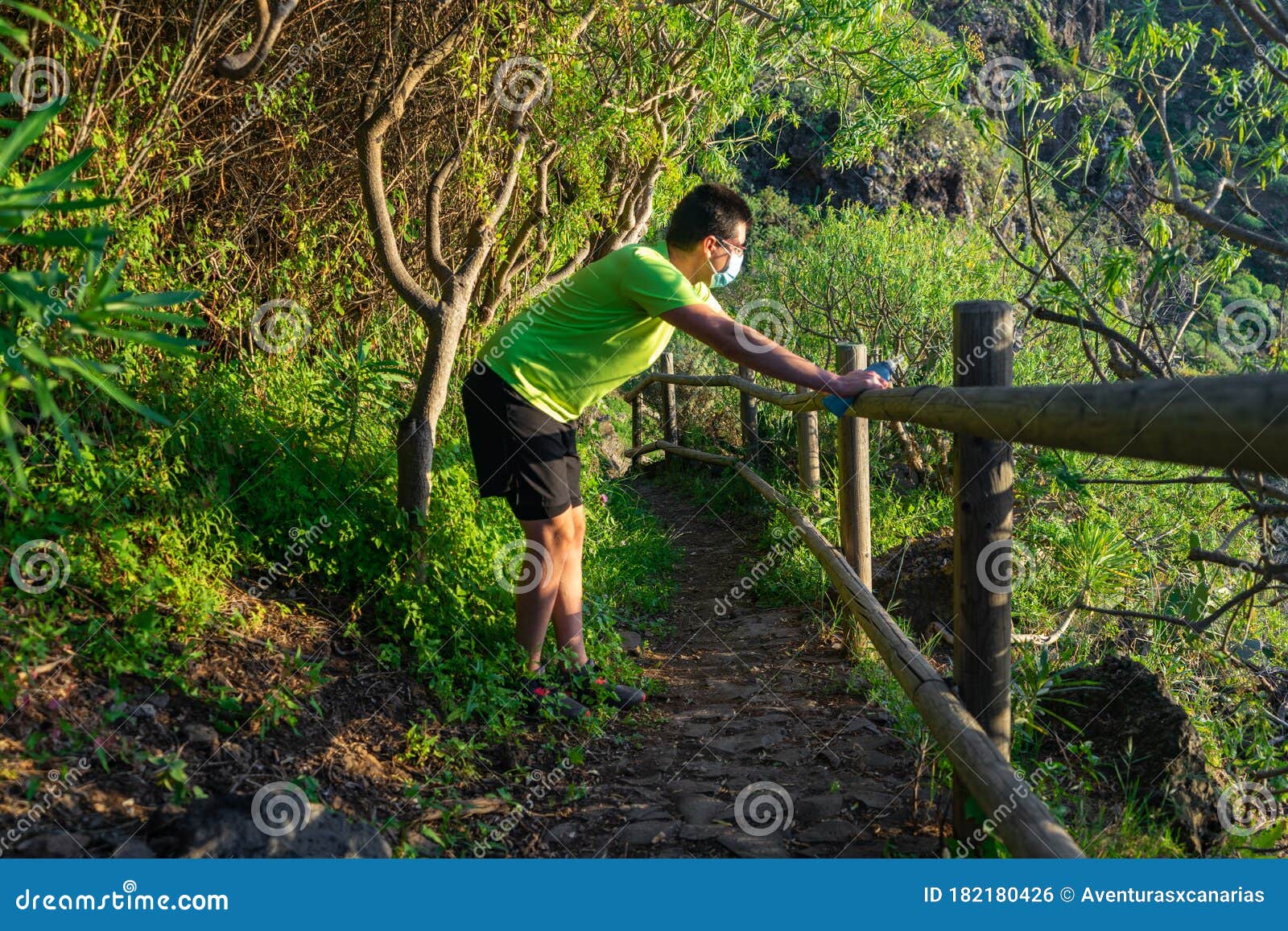 Tired Runner. the Man is in a Forest and Leans on a Wooden Railing ... Tired Runner. the Man is in a Forest and Leans on a Wooden Railing ...