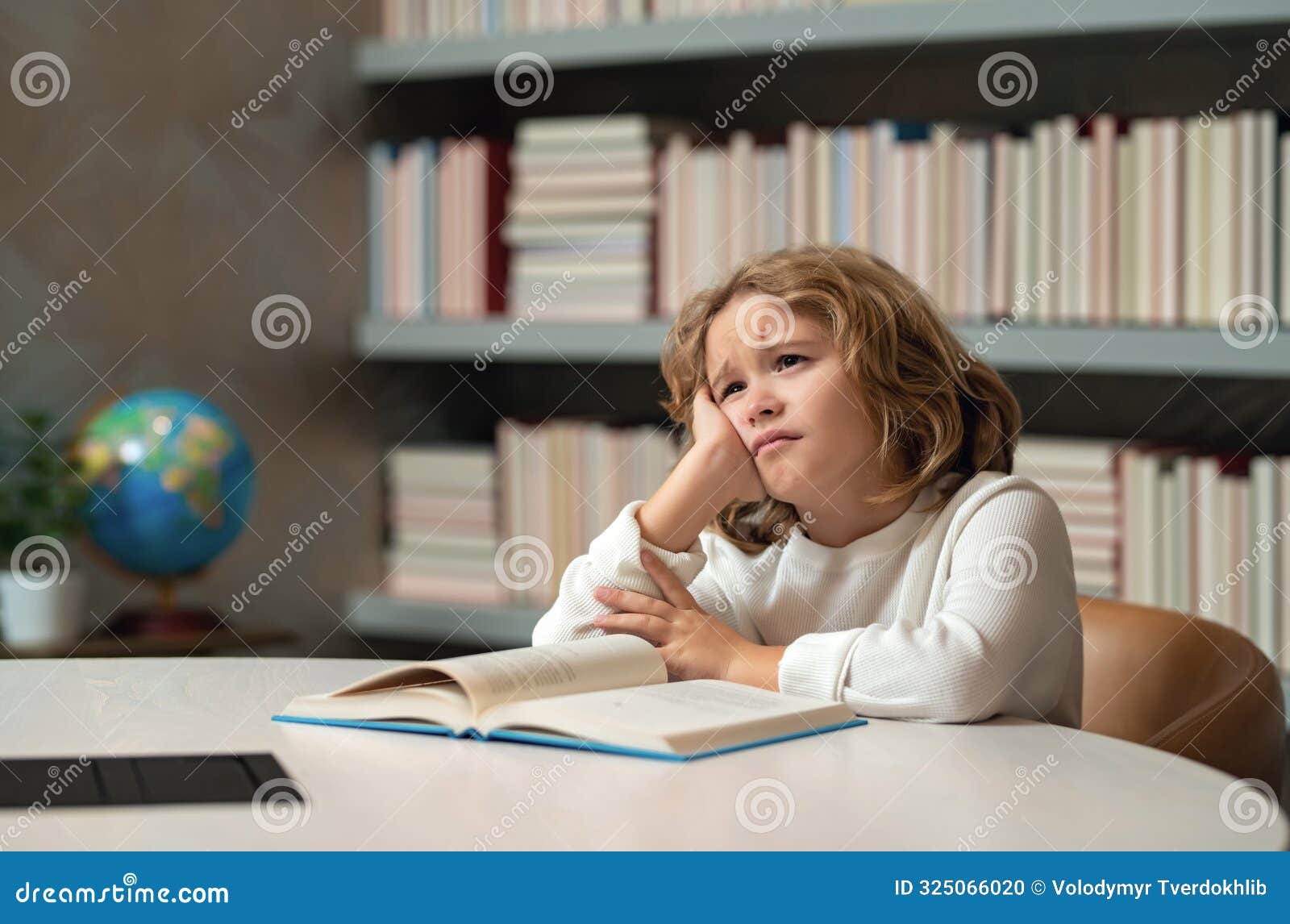 Tired School Boy, Bored Pupil at School. Pupil Reading Books in a ...