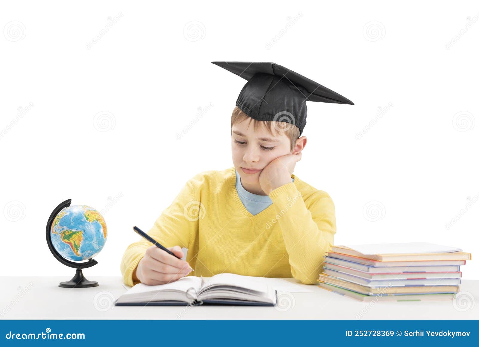 Schoolboy Does Homework Sitting At Desk In Isolation On White ...