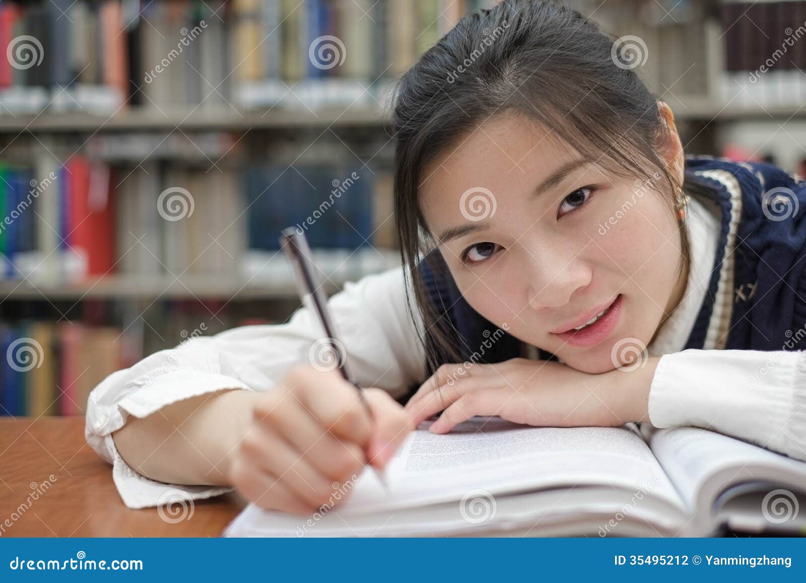 Tired Student Doing Homework in Library Stock Photo - Image of asian ...