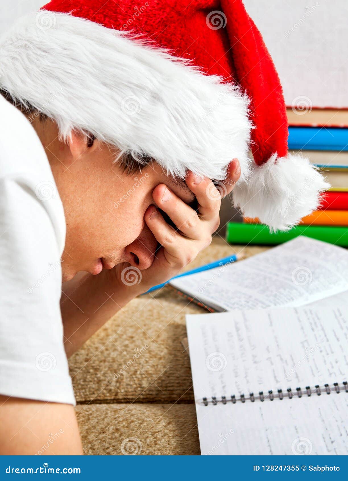 Tired Student in Santa Hat stock image. Image of home - 128247355