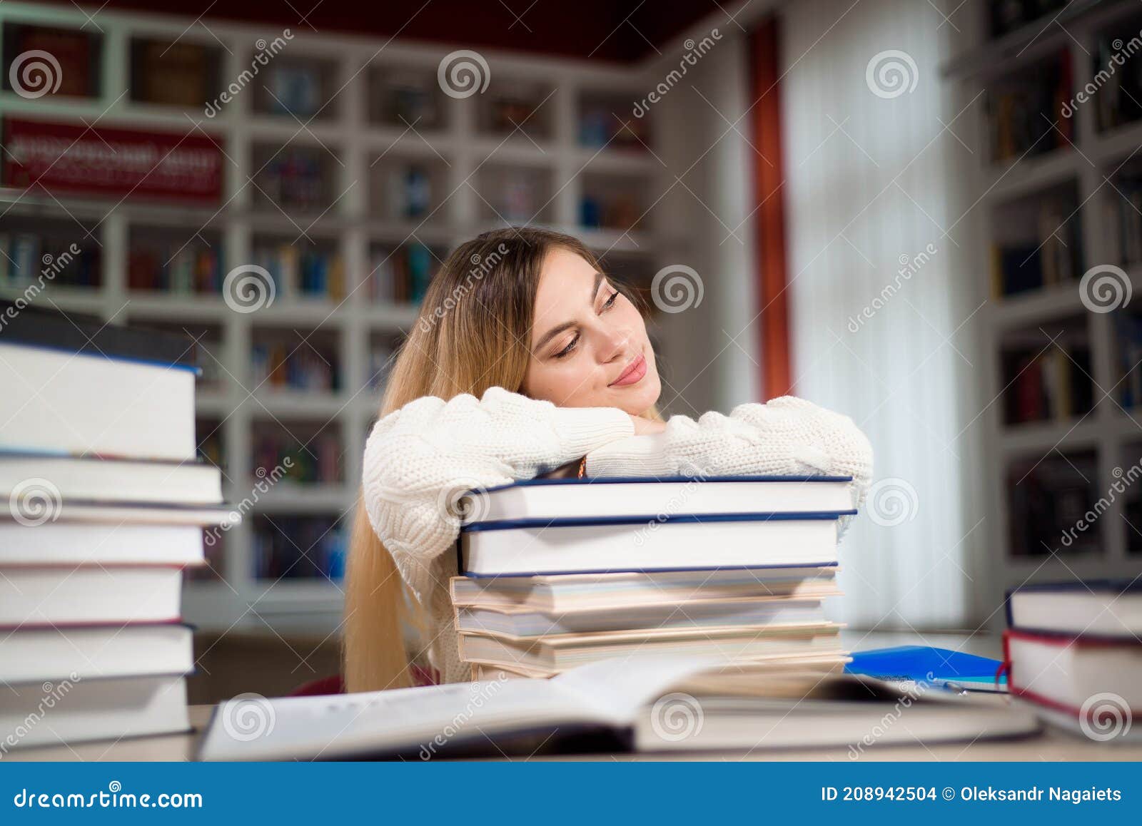 A Tired Student is Studying in the School Library. Stock Photo - Image ...