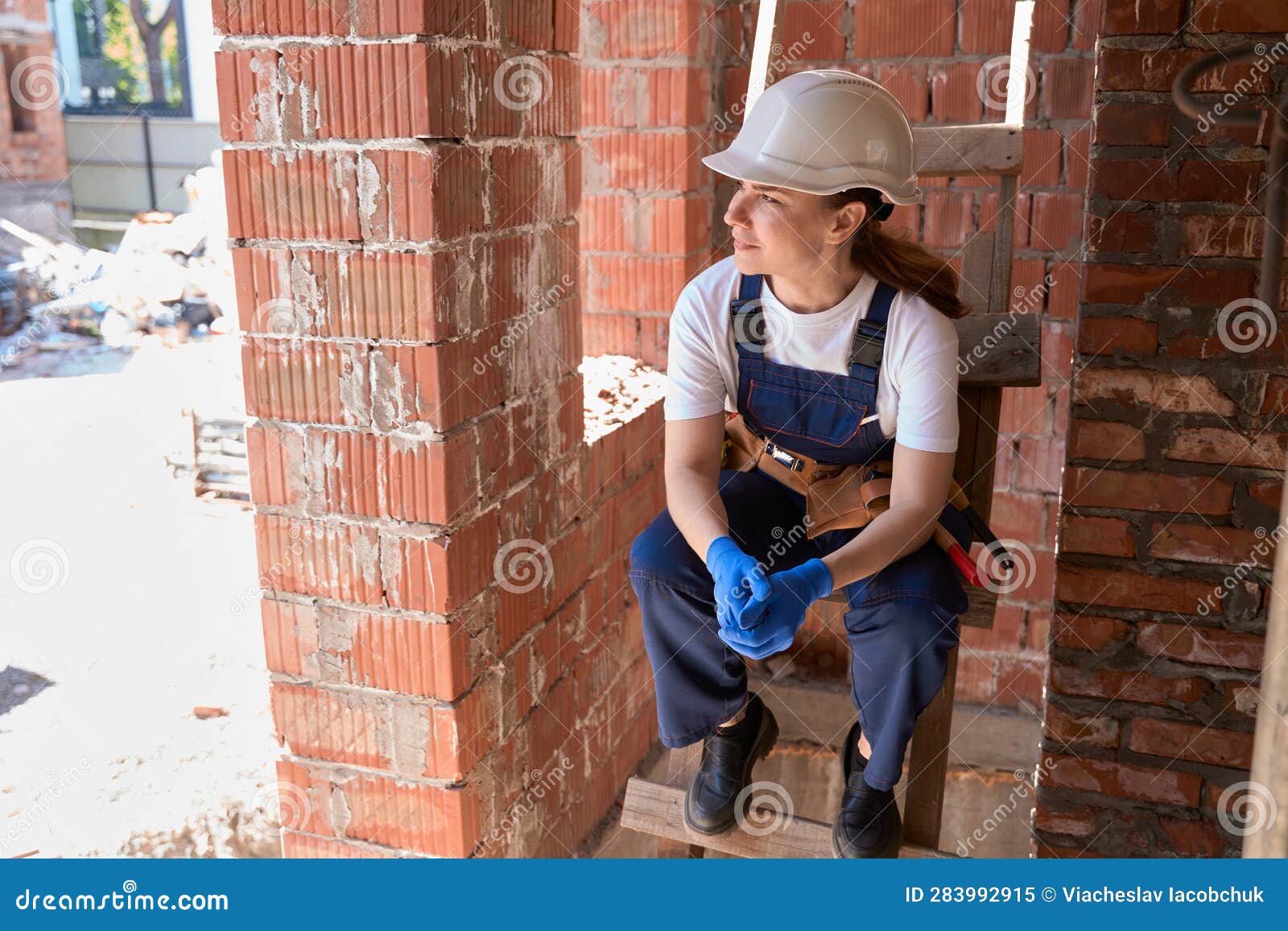 Tired Woman Building Engineer Sitting on Wooden Ladder and Resting ... Tired Woman Building Engineer Sitting on Wooden Ladder and Resting ...