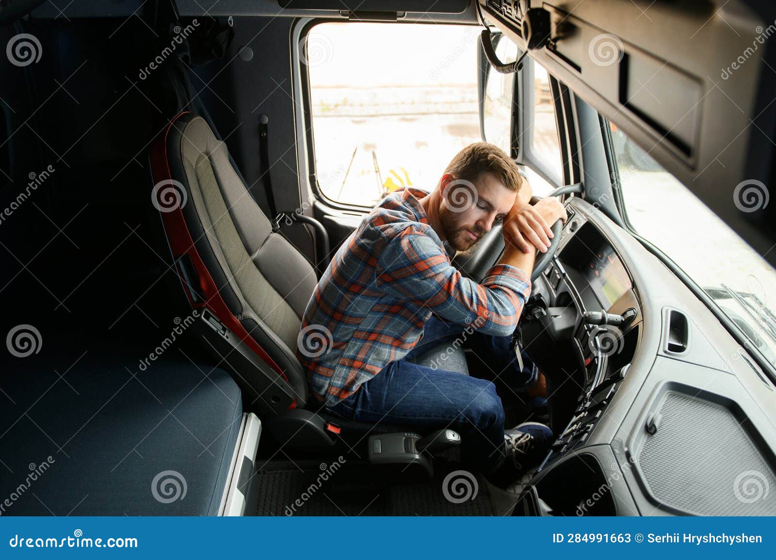 Tired of Work. Sitting in the Cabin. Young Truck Driver is with His ...