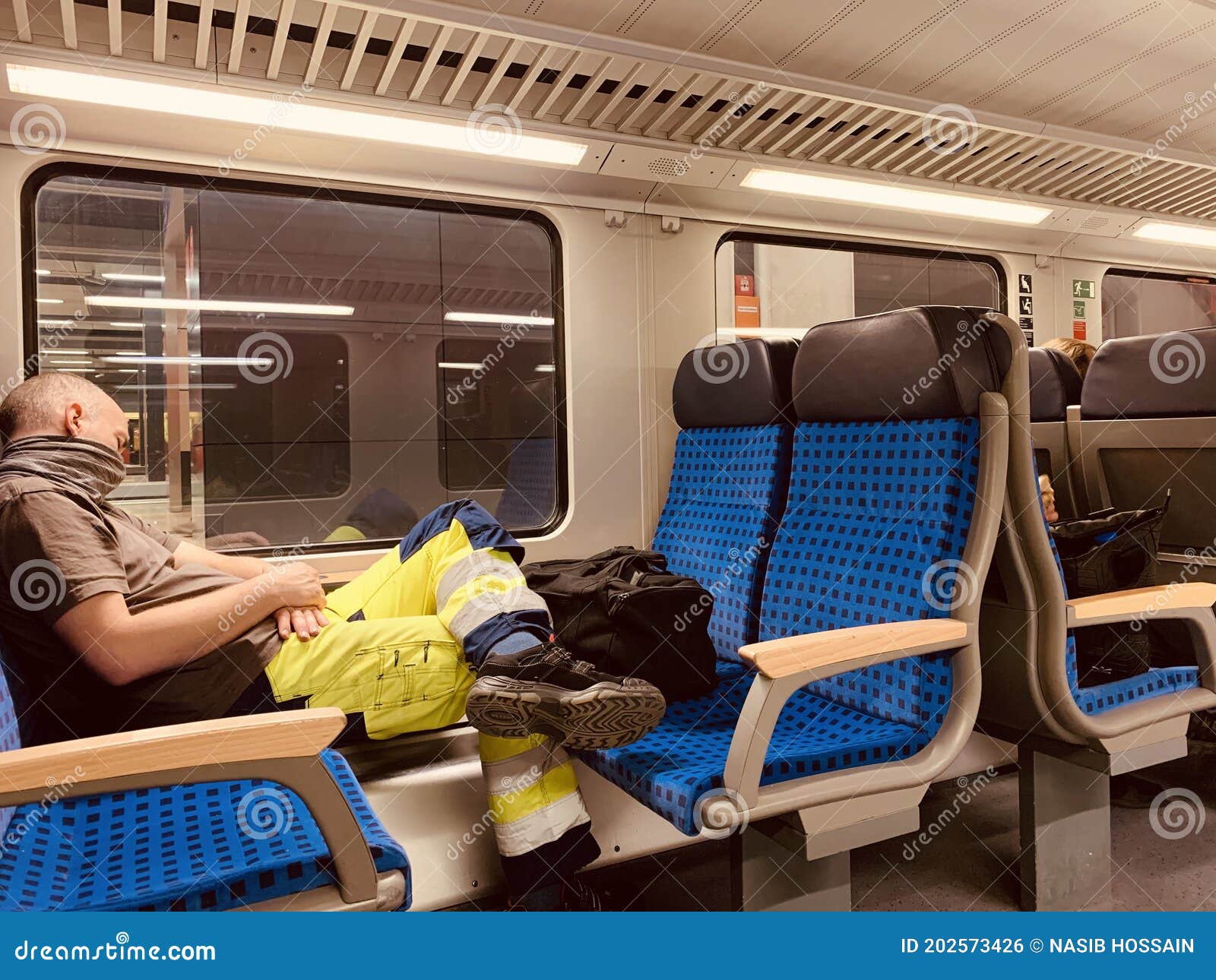 A Tired Worker Sleeping in a Chair in a Modern Train in Berlin ...