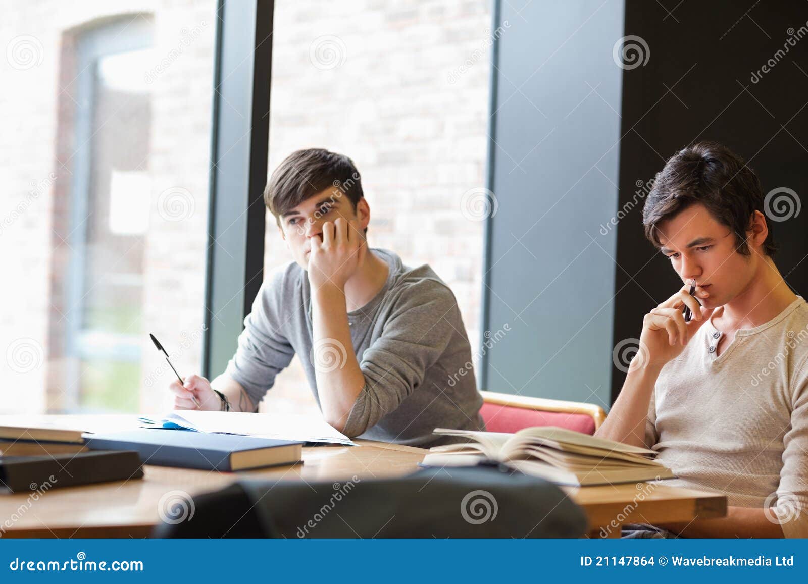 Tired Young Adults Reviewing Their Notes Stock Photo - Image of notes ...