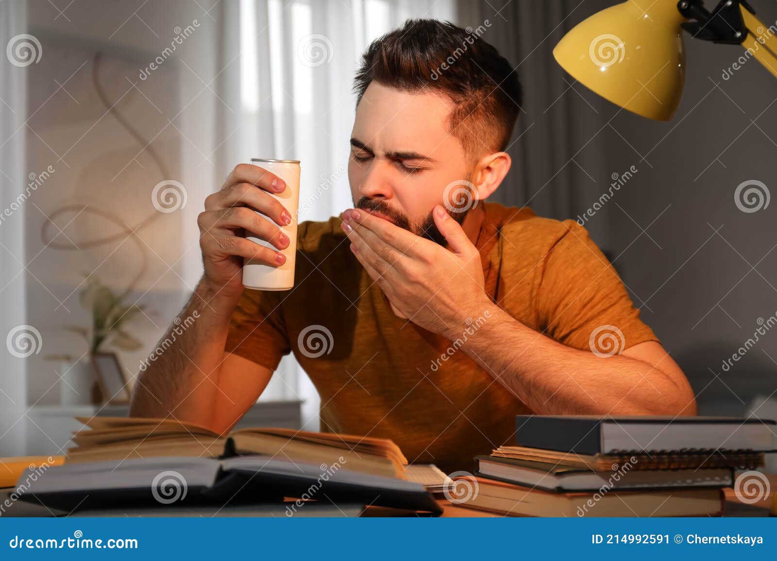 Tired Young Man with Energy Drink Studying at Home Stock Image - Image ...