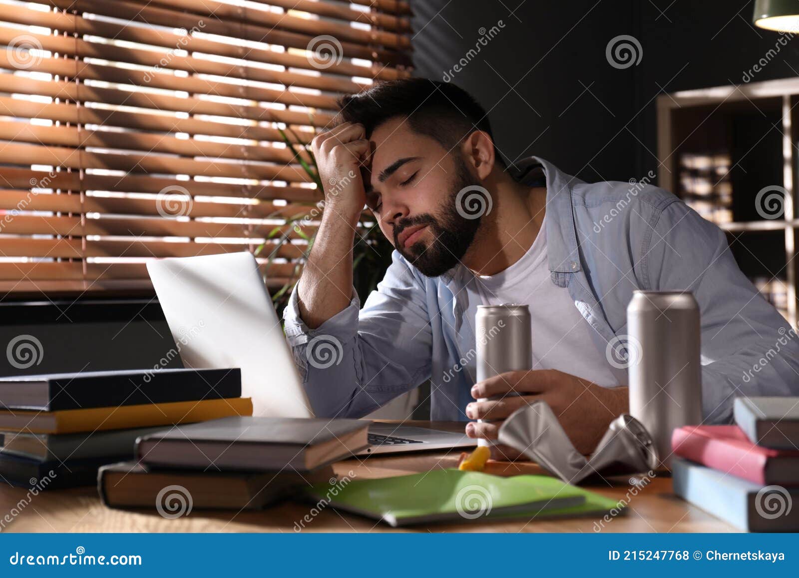 Tired Young Man with Energy Drink Studying at Home Stock Photo - Image ...