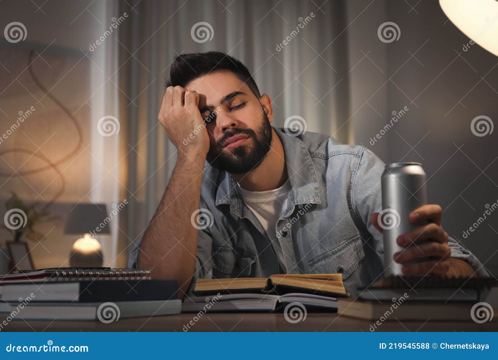 Tired Young Man with Energy Drink Studying at Home Stock Photo - Image ...