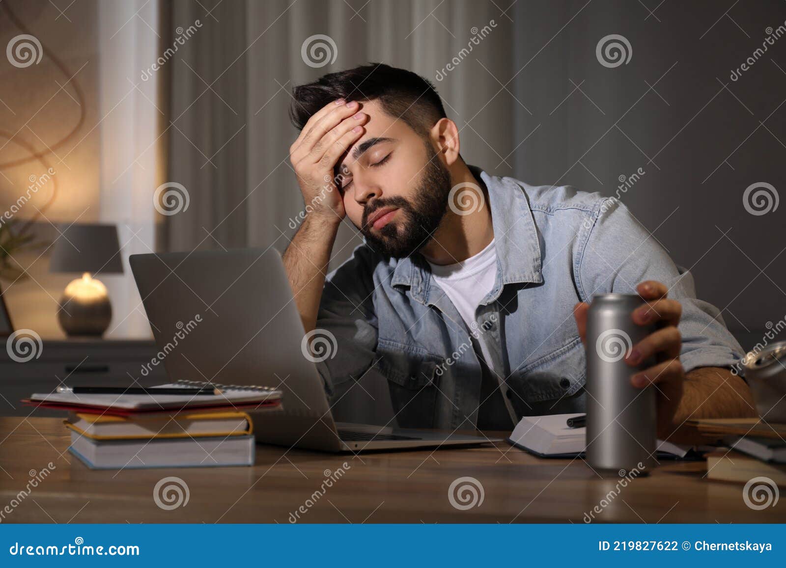 Tired Young Man with Energy Drink Studying at Home Stock Photo - Image ...