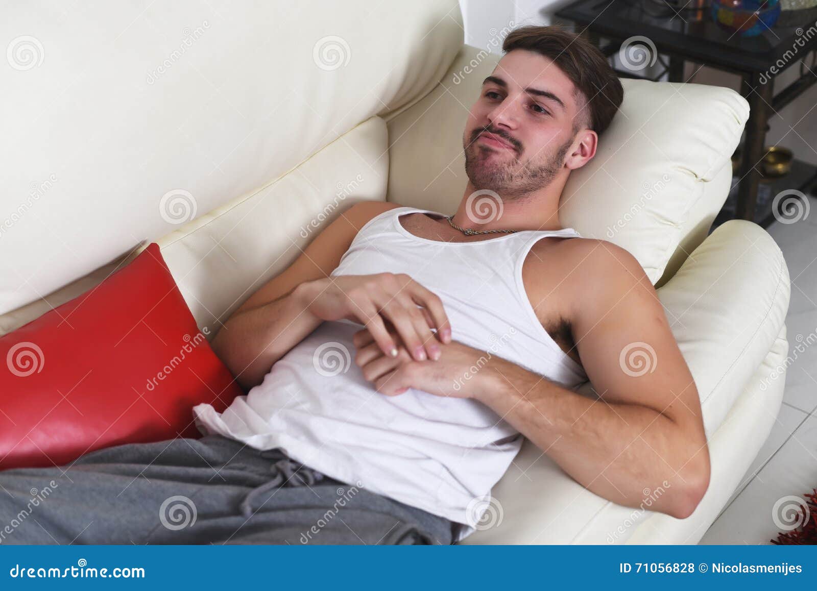 Tired Young Man Lying on White Sofa Stock Photo - Image of exhaustion ...