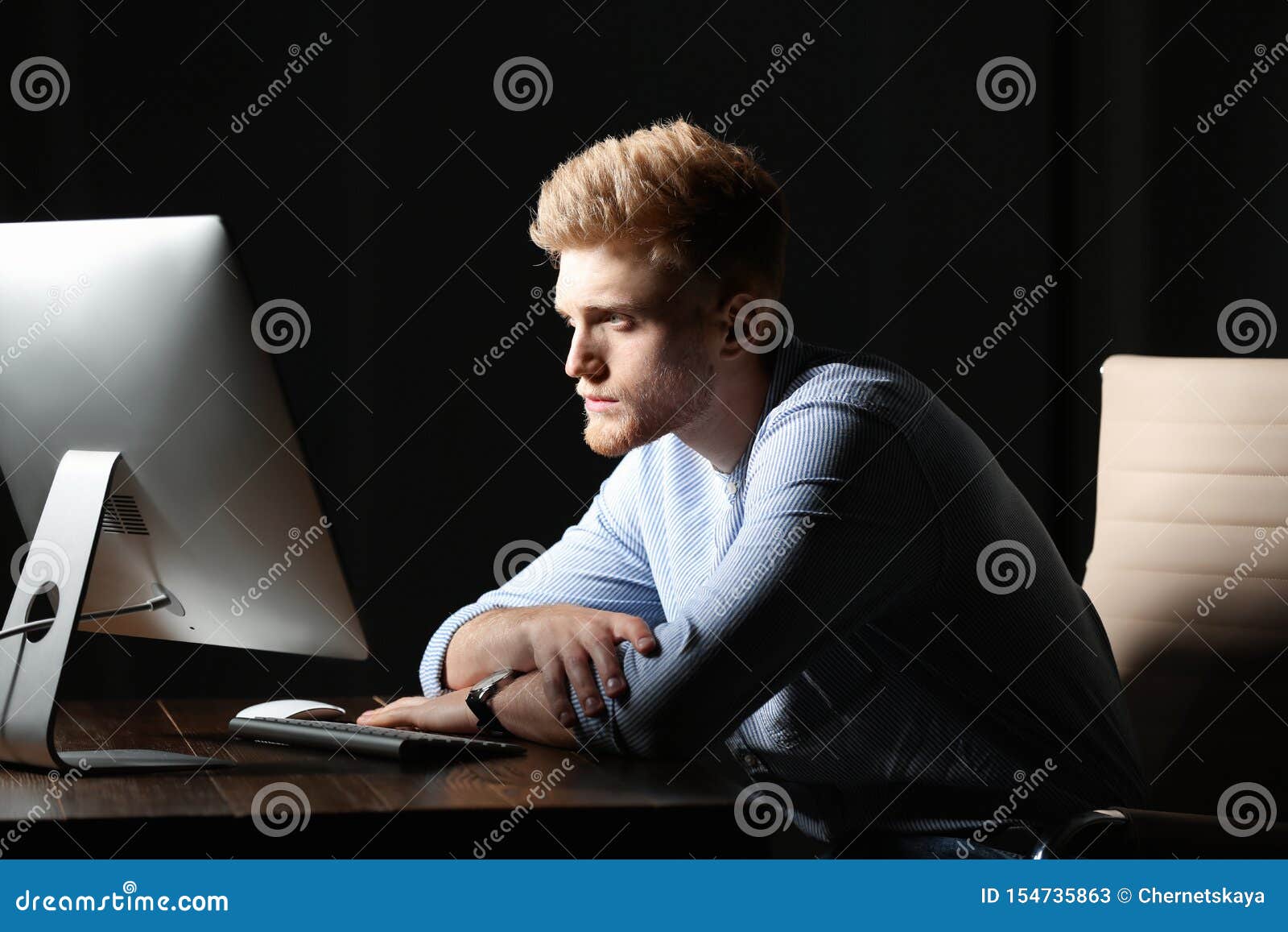 Tired Young Man Working in Office Alone at Stock Image - Image of ...