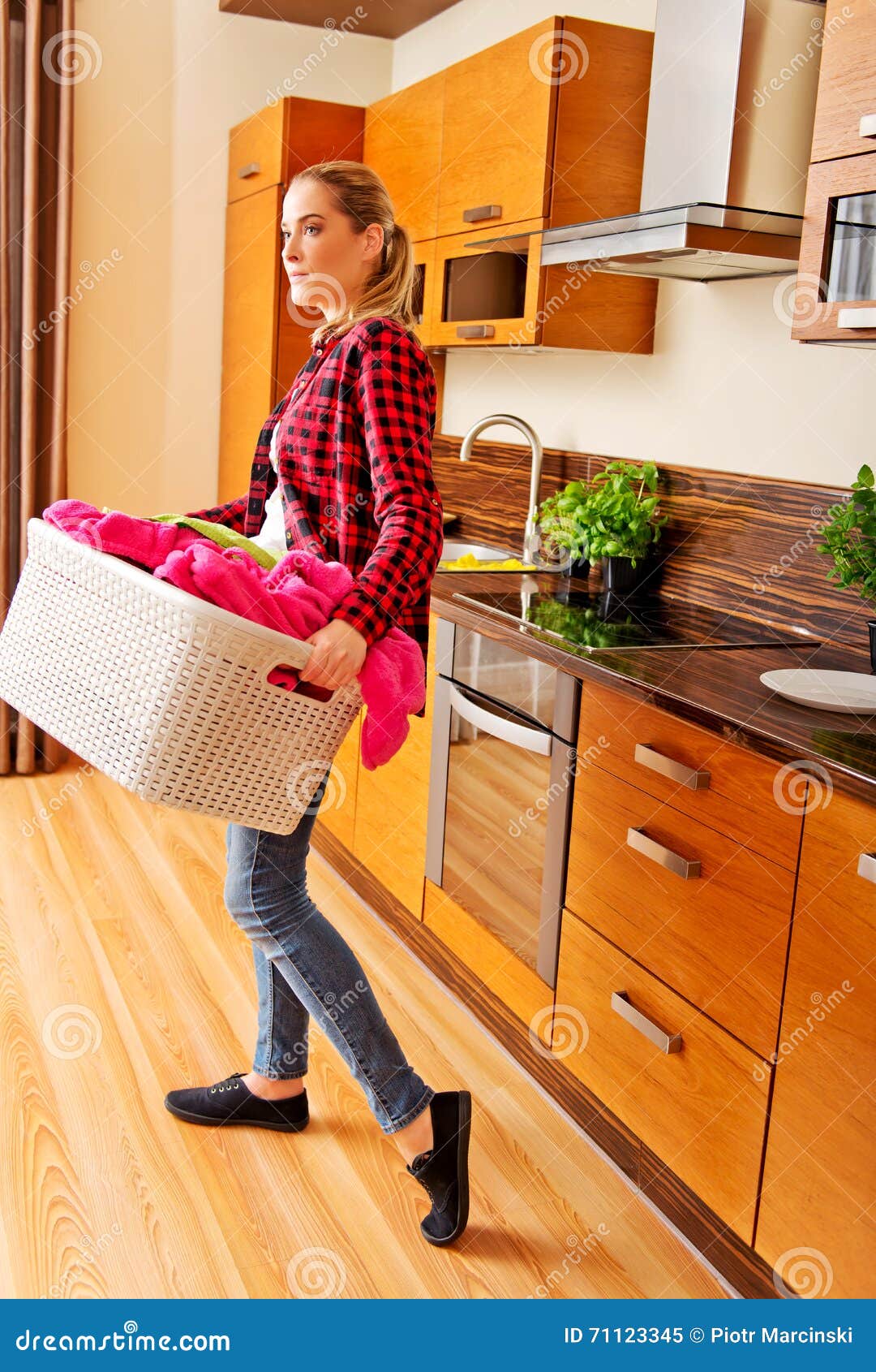 Tired Young Woman Carrying Laundry Basket in Kitchen Stock Image ...