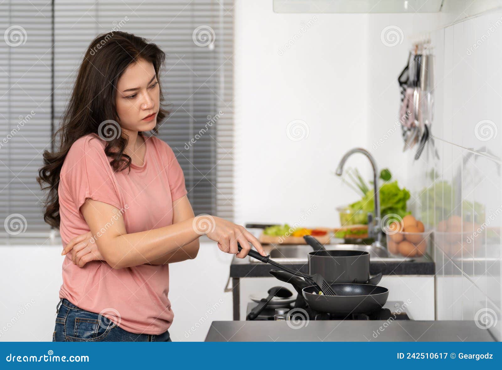 Tired Woman Cooking and Preparing Food in the Kitchen at Home Stock ...