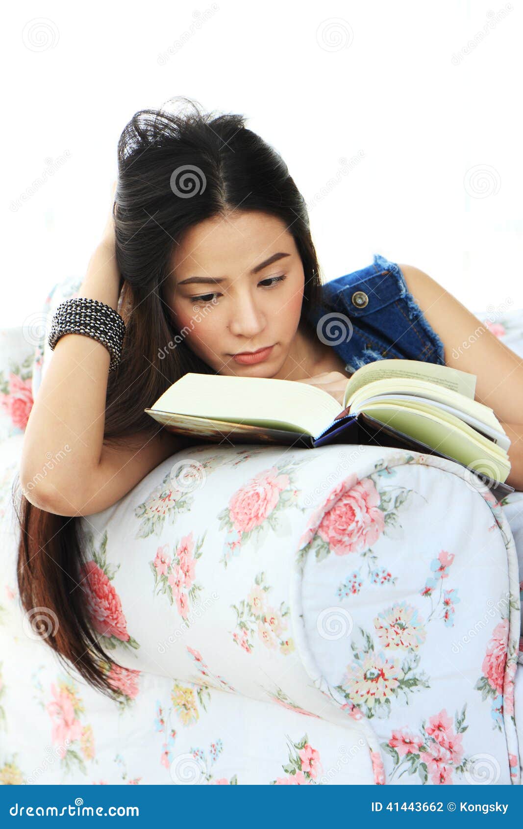Tired Young Woman Reading a Book at Home on Sofa. Stock Photo - Image ...