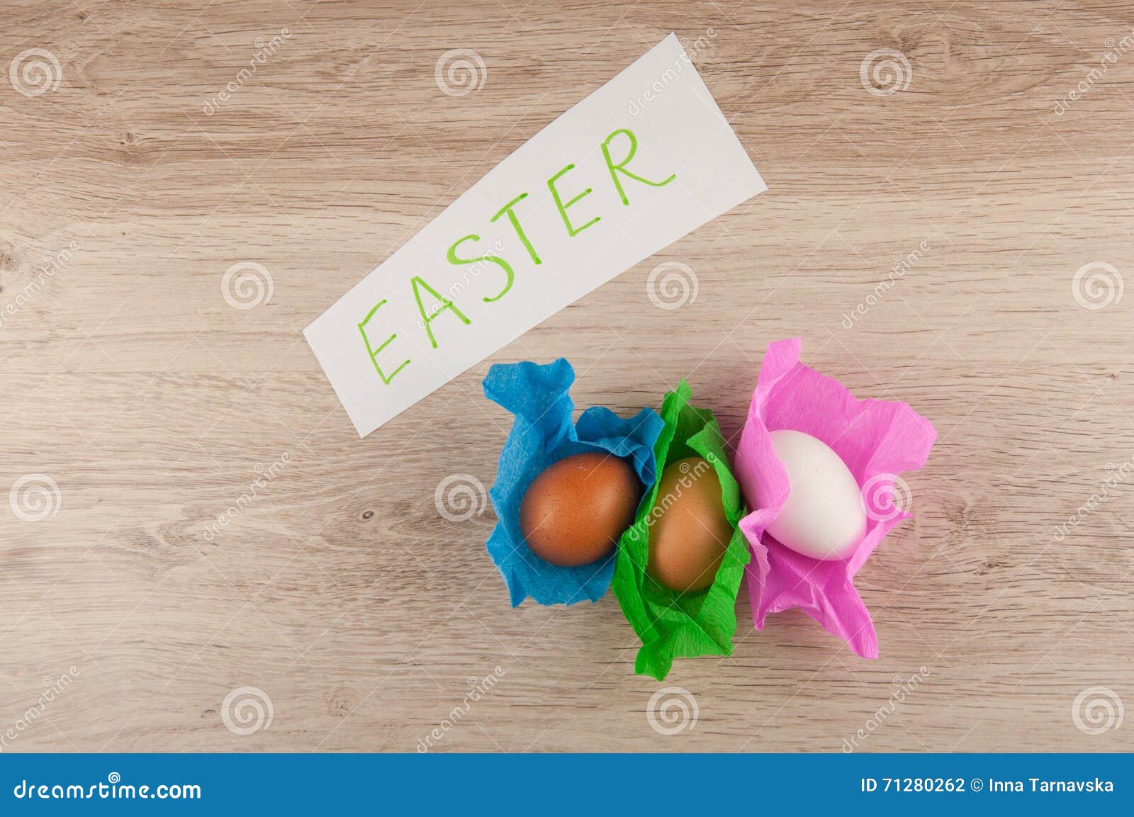 Title Easter and Three Chicken Eggs in Colored Paper Wrapper Laying on ...