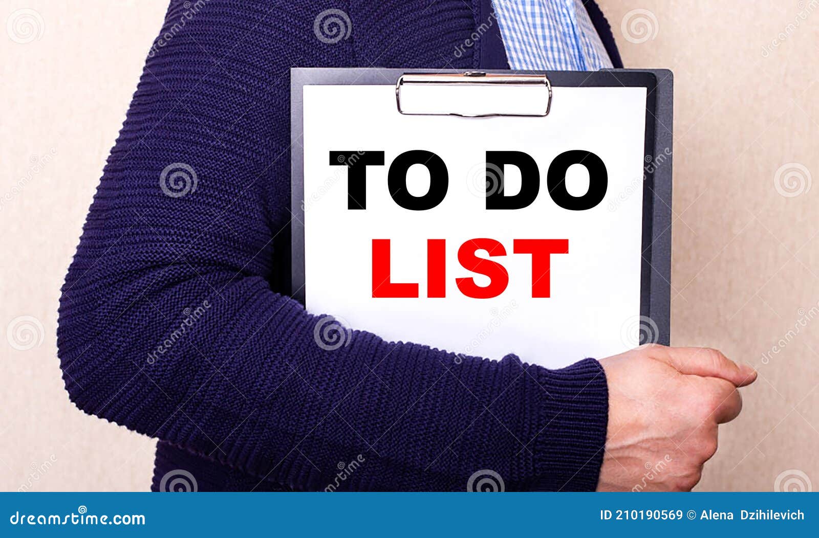 TO DO LIST is Written on a White Sheet Held by a Man Standing Sideways ...