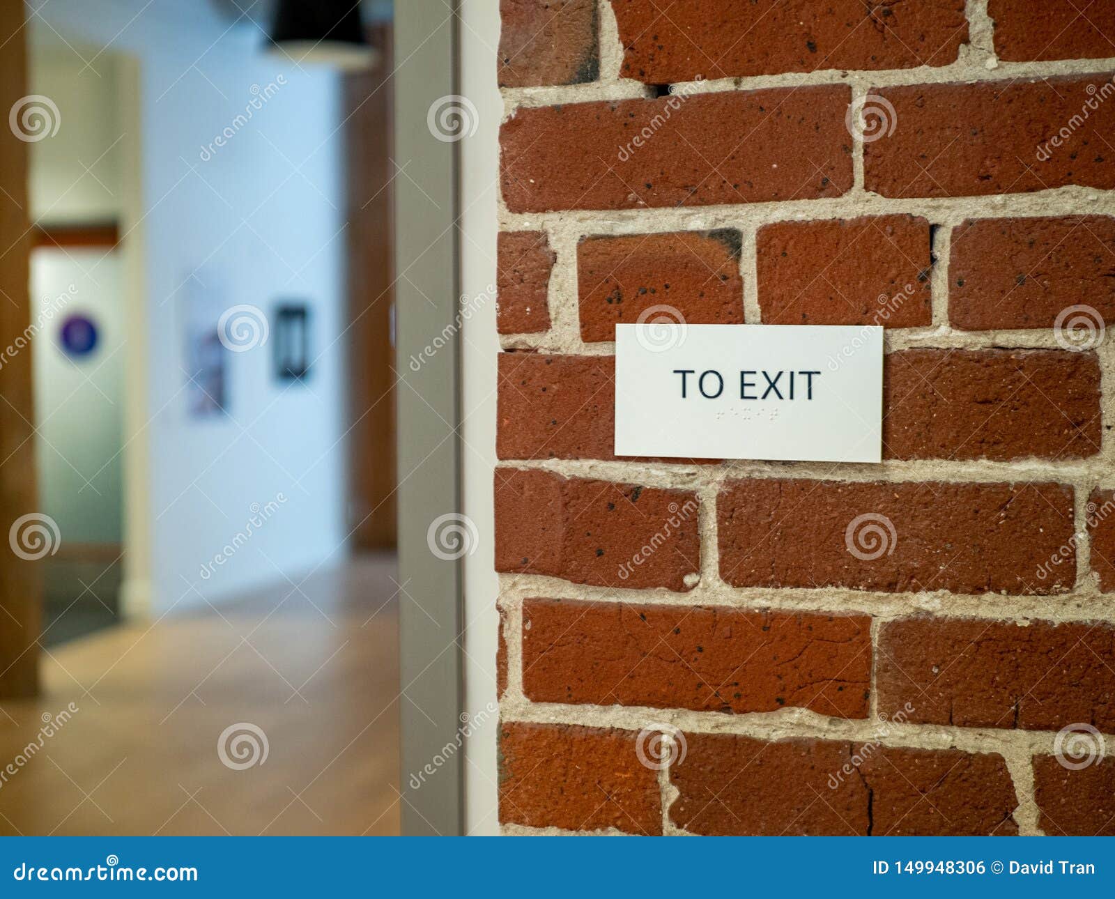 To Exit Sign on Brick Wall in a Modern Warehouse Lobby Office Area ...