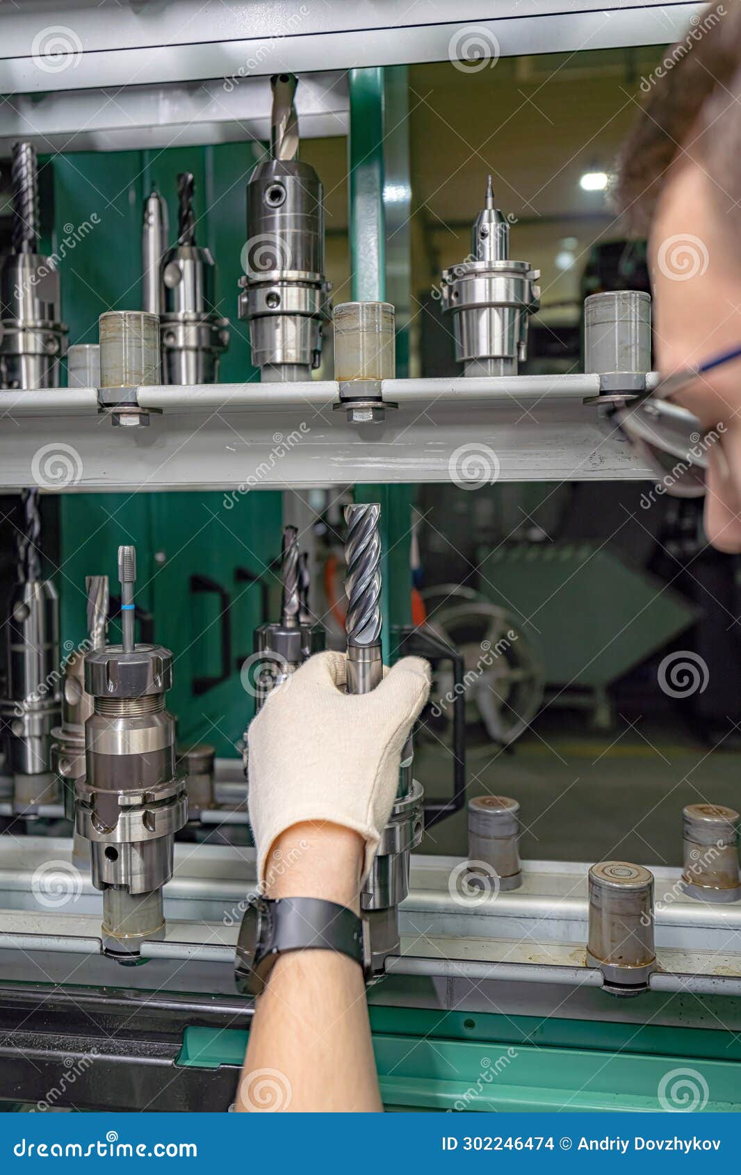 To Operate A Cnc Machine A Worker Selects And Inspects The Required Cutter From The Rack And