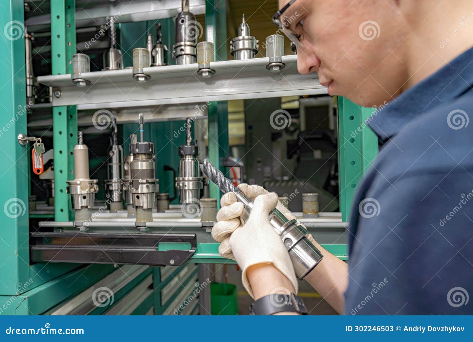 To Operate a CNC Machine, a Worker Selects and Inspects the Required ...