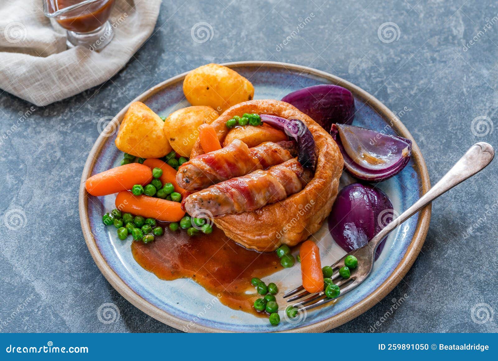 Toad-in-the-hole stock photo. Image of carrots, bangers - 259891050