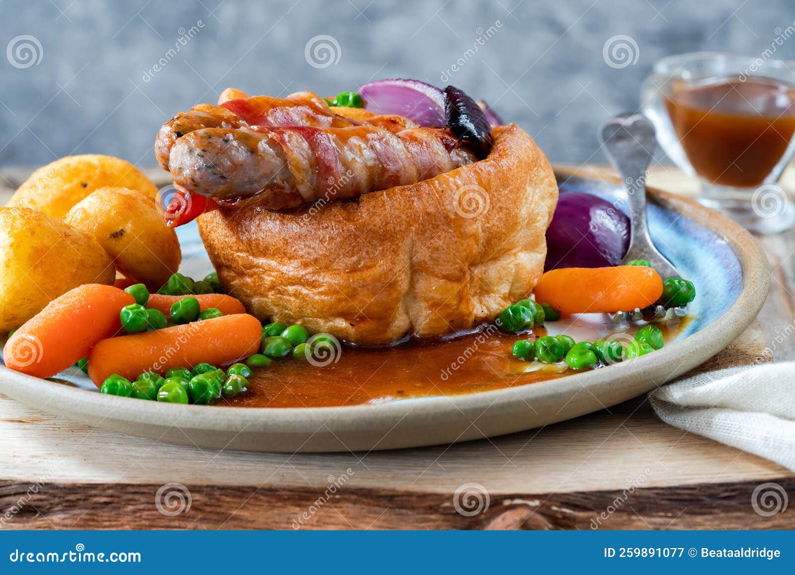 Toad-in-the-hole stock image. Image of roasted, baked - 259891077