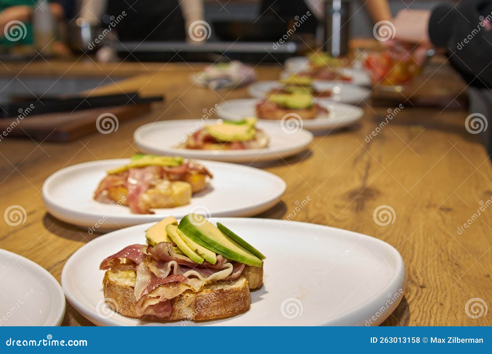 Toast with Bacon and Avocado on a Plate Standing on a Wooden Table ...