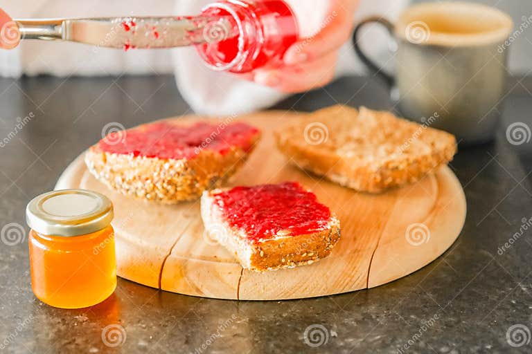 Toast With Jambun With Raspberry Jambuns With Honey And Jamhands Spread Honey On A Fresh Bun