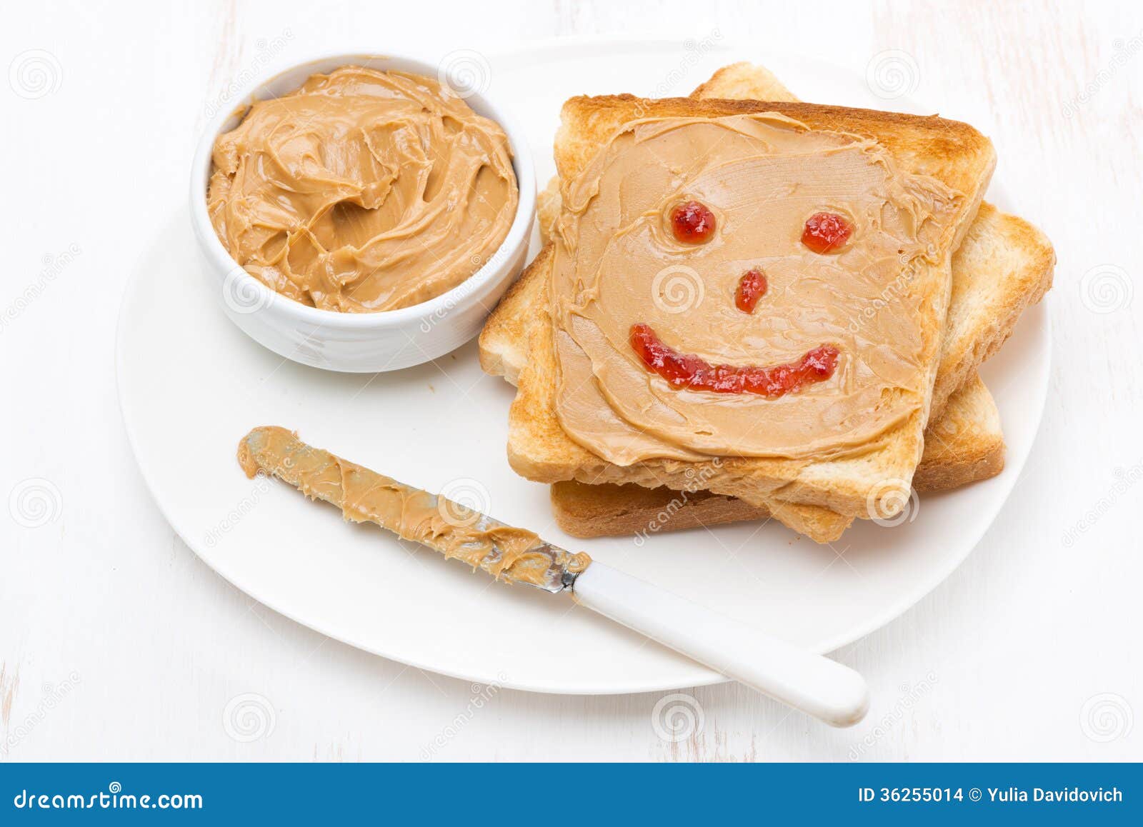 Toast with Peanut Butter and a Painted Smile, Top View Stock Photo ...
