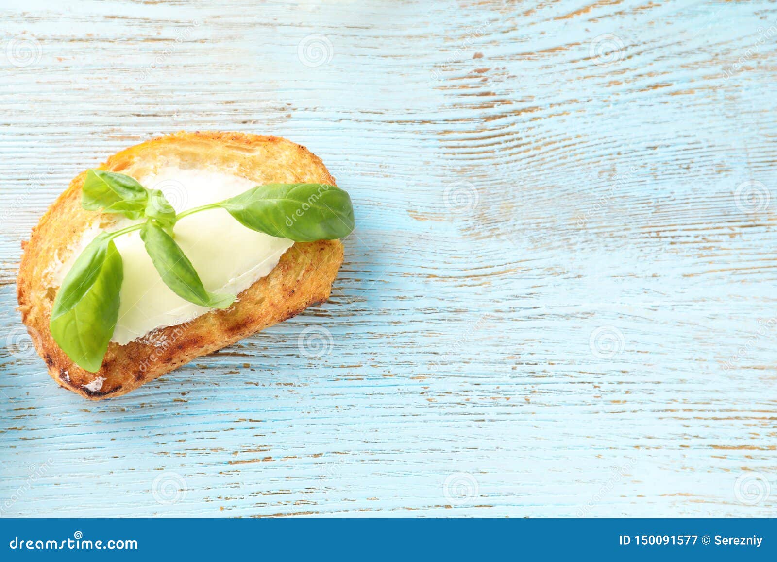 Toasted Bread with Cream Cheese and Basil on Table Stock Image - Image ...