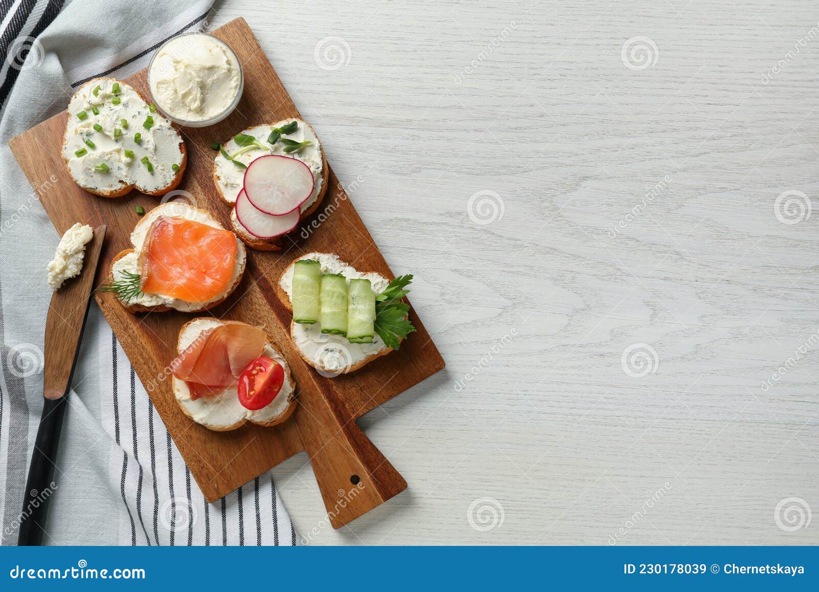 Toasted Bread with Cream Cheese and Different Toppings on White Wooden ...