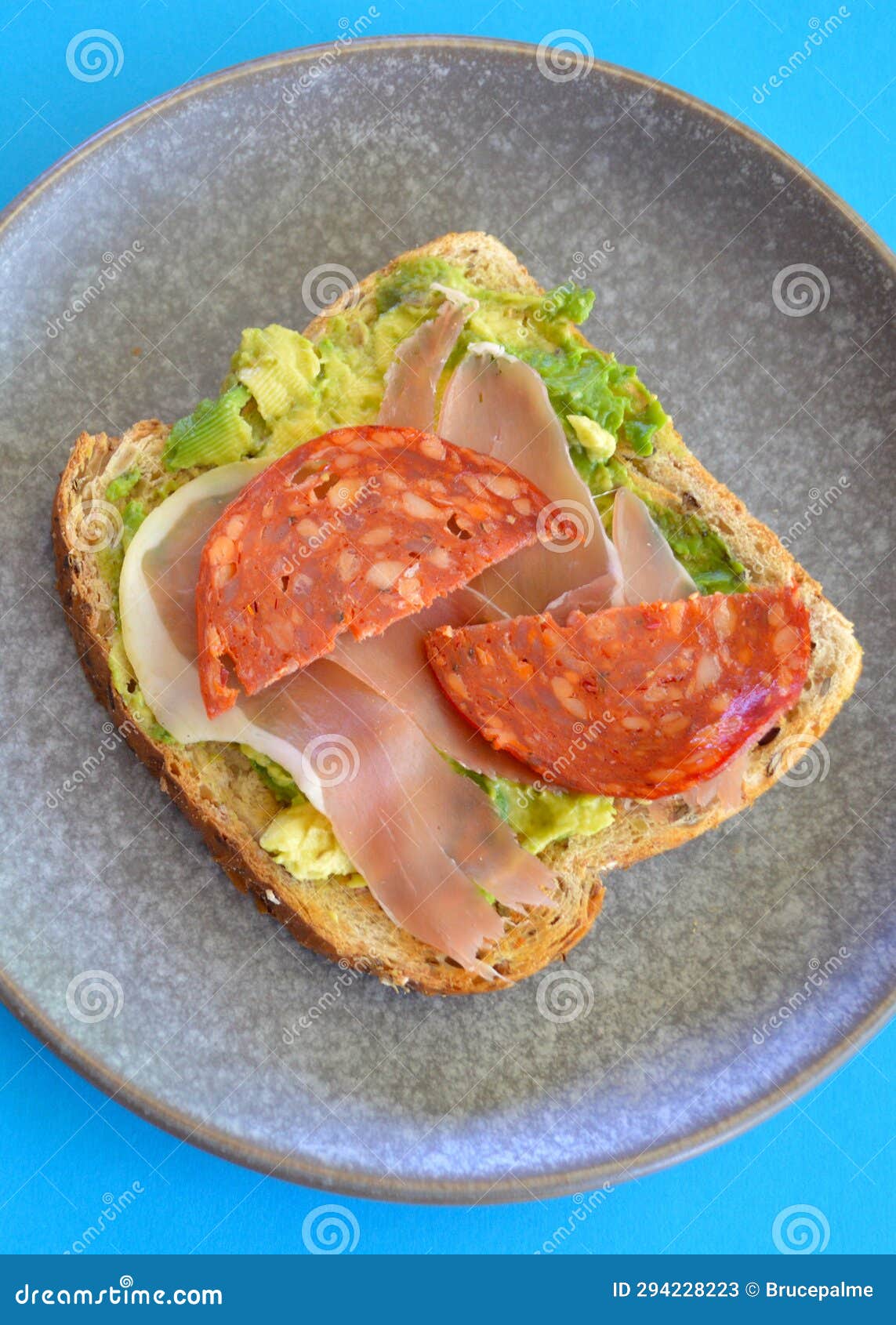 Toasted Multi Grain Bread with Smashed Avocado and Hot Italian Salami ...