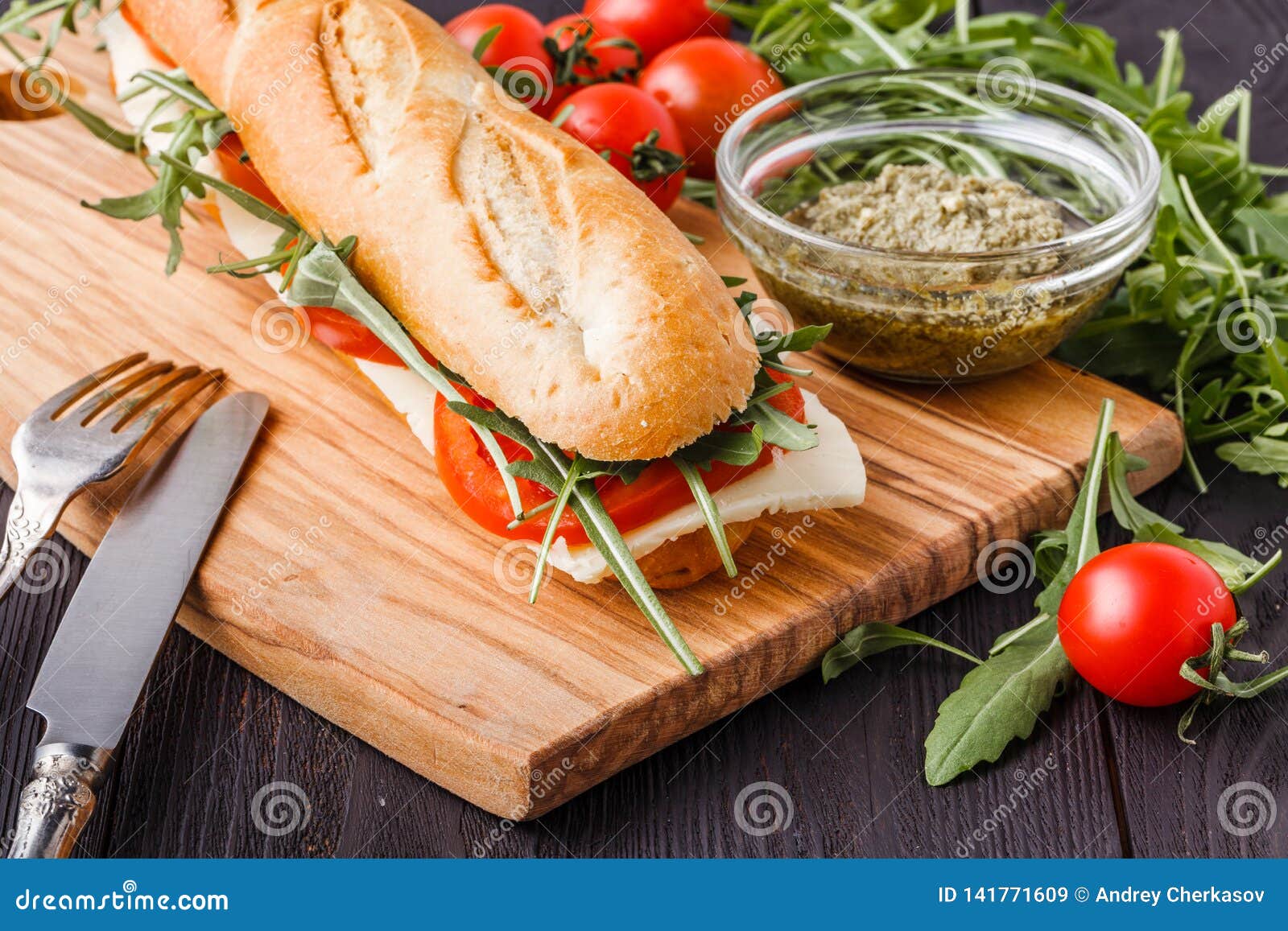 Toasted Panini with Ham, Cheese and Arugula Sandwich on Cutting Board ...