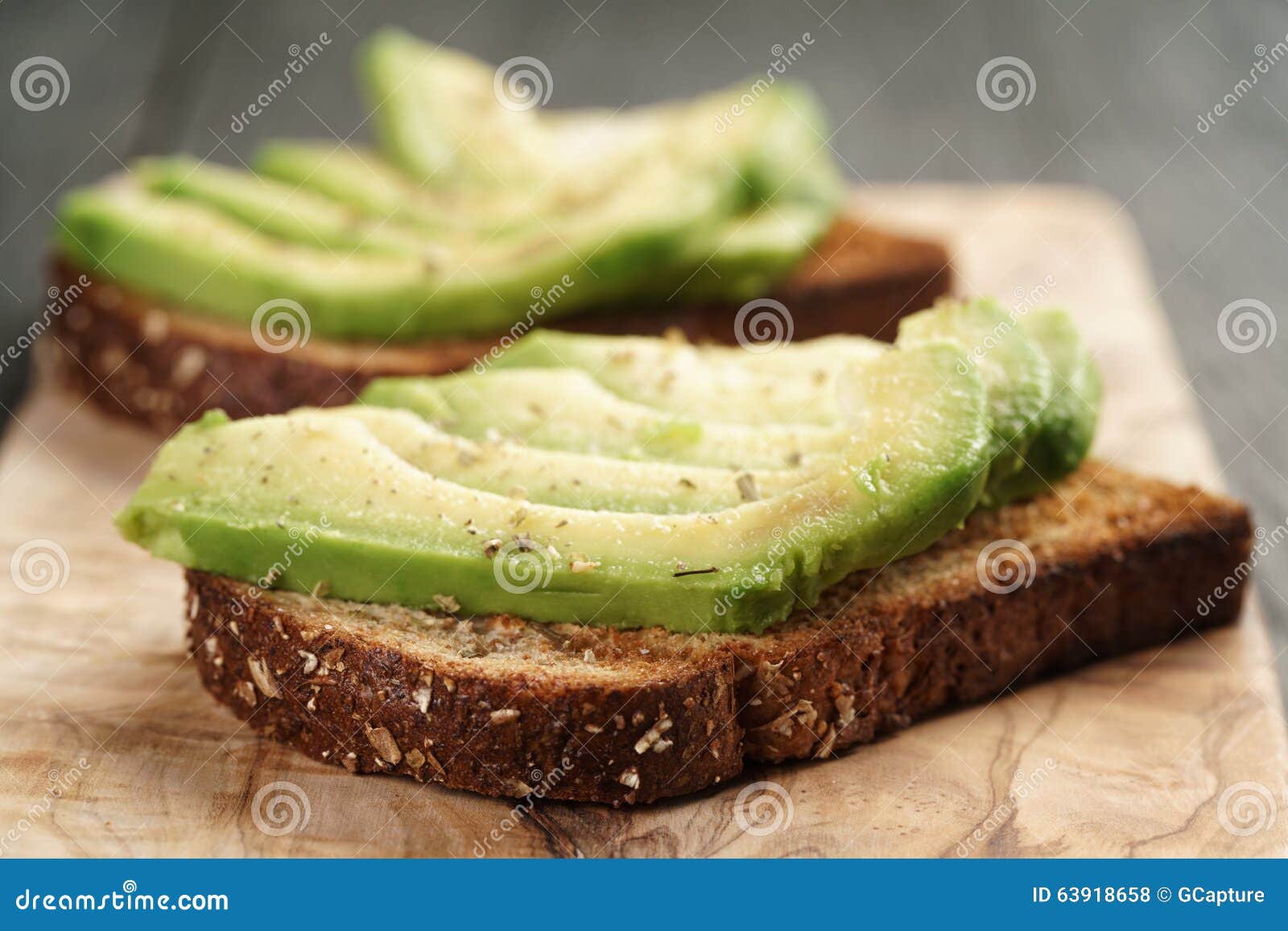 Toasted Rye Bread with Sliced Avocado and Herbs Stock Photo - Image of ...