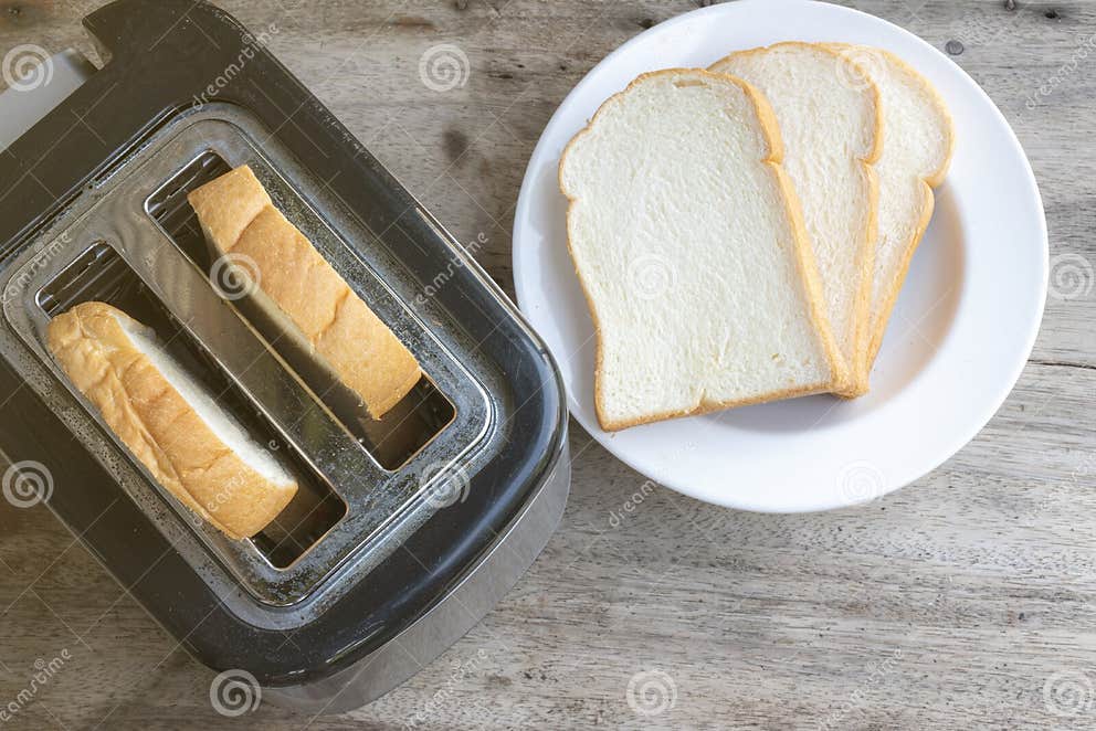 Toaster with Bread on a Plate on a Wooden Table Stock Image - Image of ...