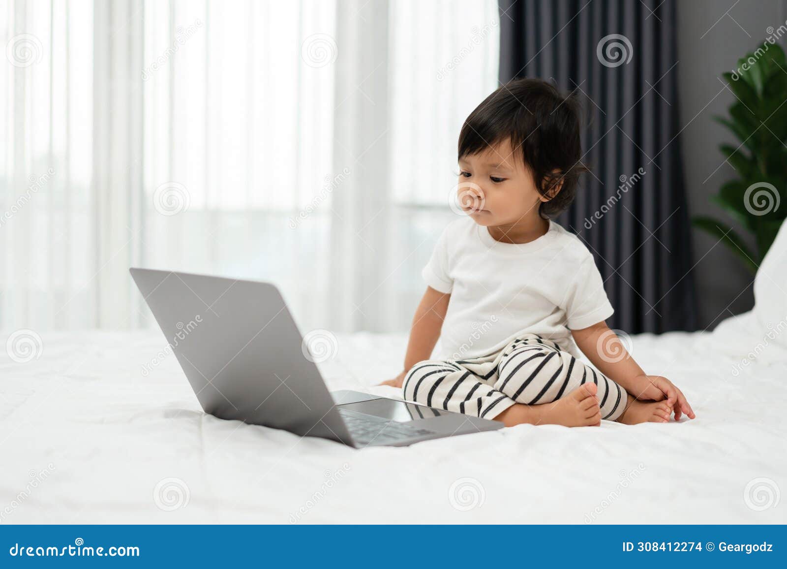 Toddler Baby Watching Laptop Computer on Bed Stock Photo - Image of ...