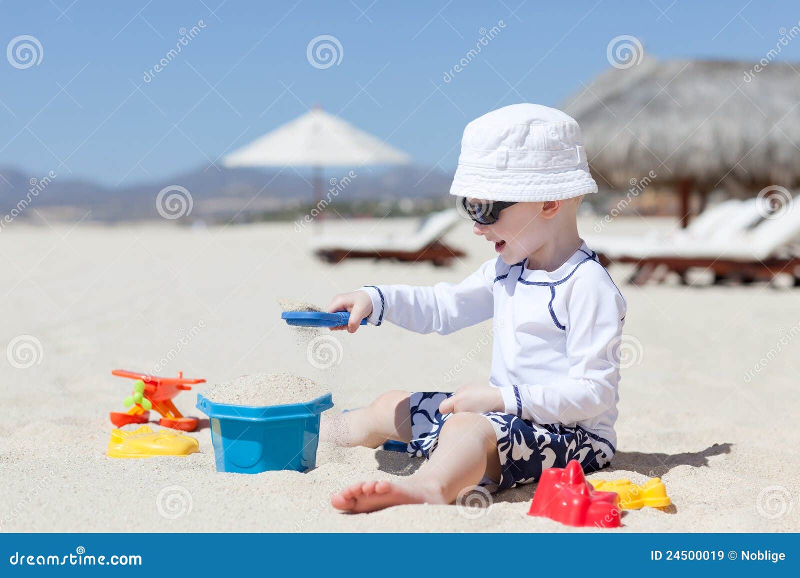 Toddler at the beach stock image. Image of cheerful, sand - 24500019