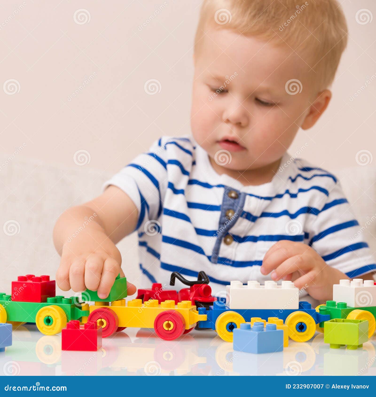 Toddler Boy Playing with Colorful Plastic Bricks at the Table. Toddler ...