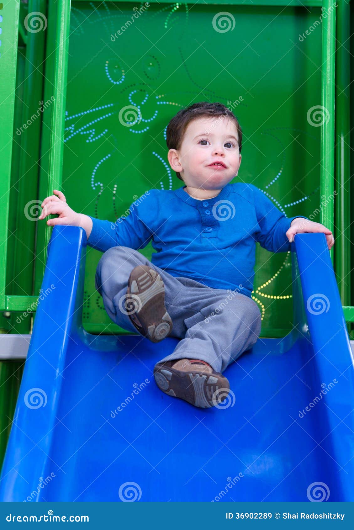 Toddler Boy Smiling on a Slide Stock Image - Image of cute, looking ...