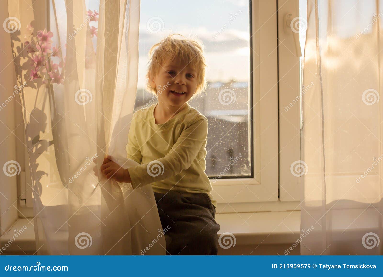 Toddler Child, Sitting on the Window on Sunset, Looking Out Stock Image ...