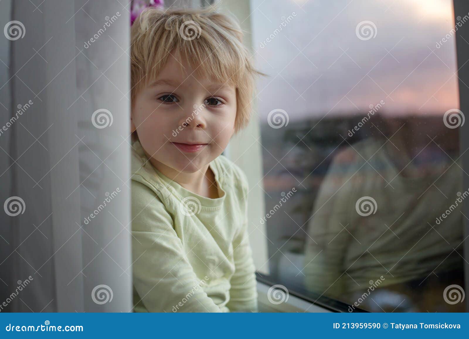 Toddler Child, Sitting on the Window on Sunset, Looking Out Stock Photo ...