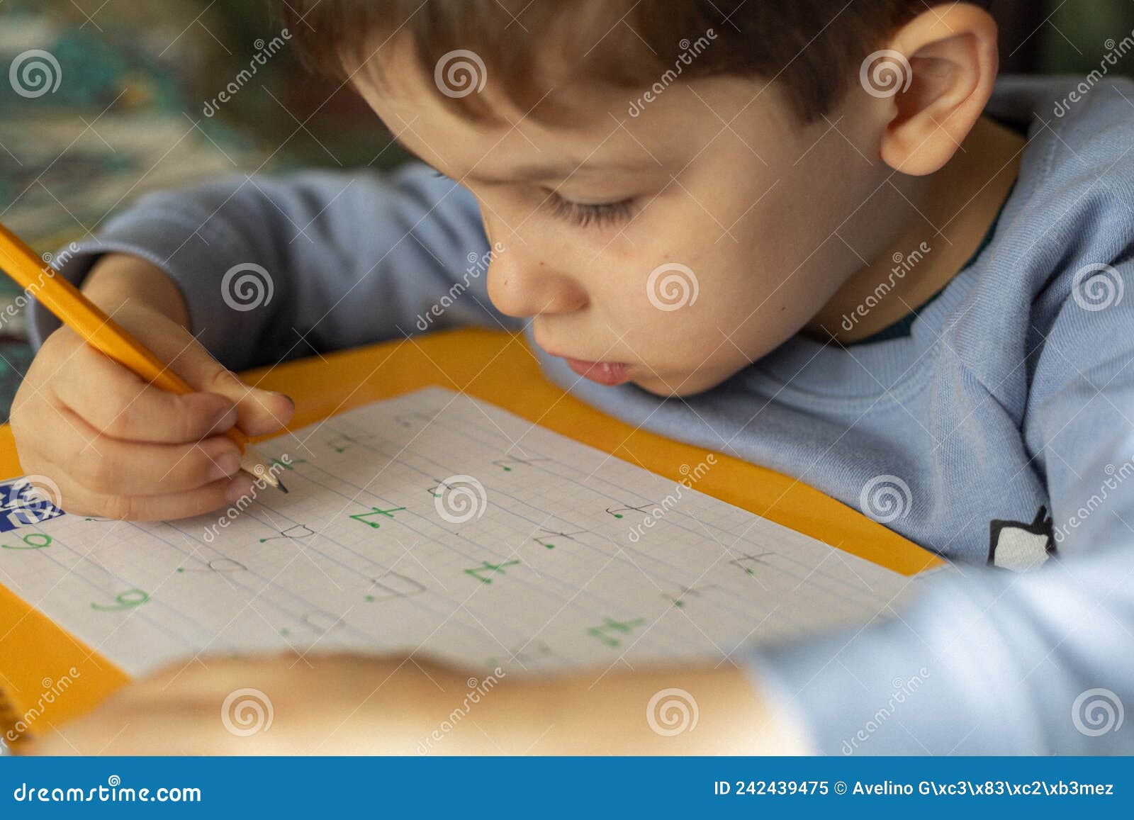 Toddler Doing Homework by Writing Letters and Numbers in Notebook Stock ...