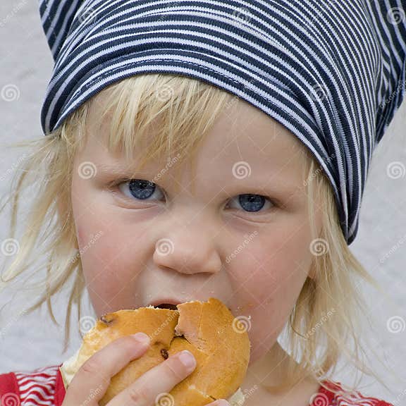 Toddler eating bread roll stock image. Image of charming - 5873157