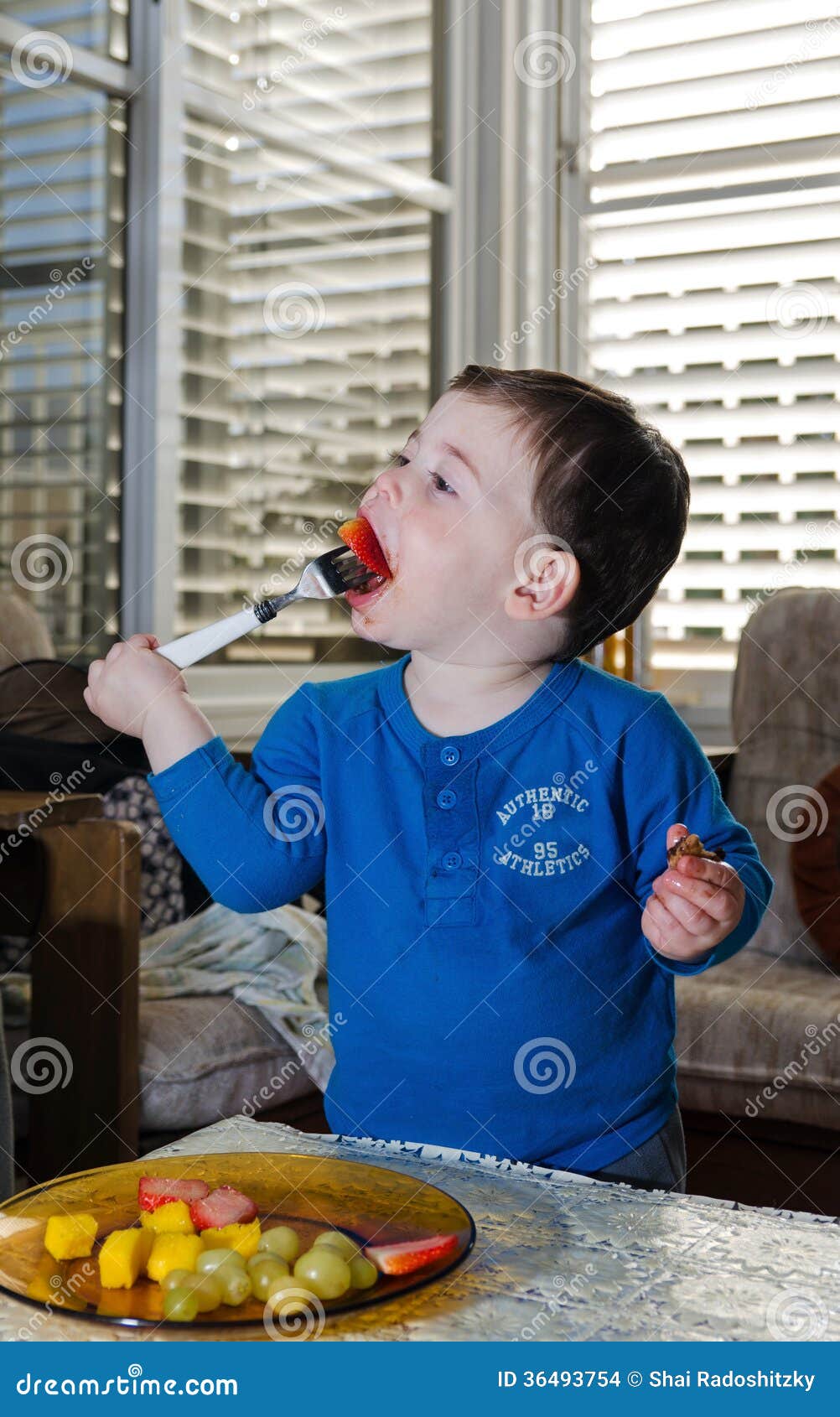 Toddler eating with a fork stock photo. Image of open - 36493754