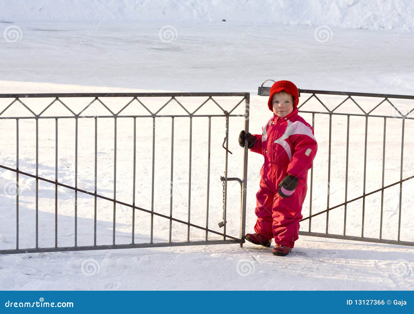 Toddler at the gate stock photo. Image of stand, cold - 13127366